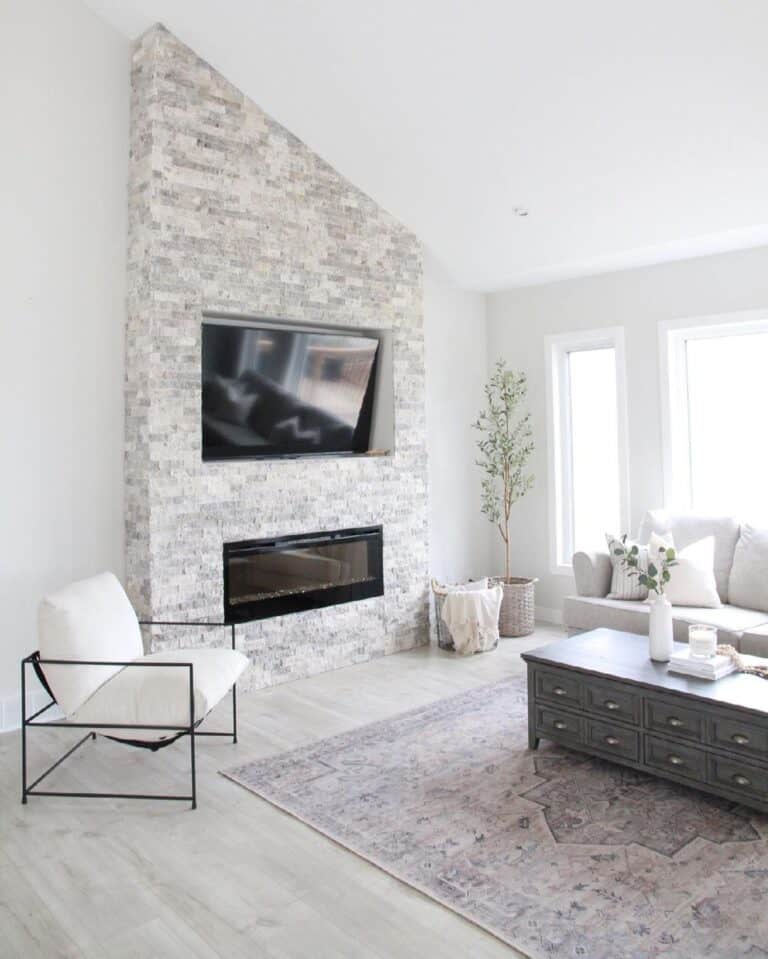 Slanted Ceiling Living Room With Brick Fireplace - Soul & Lane
