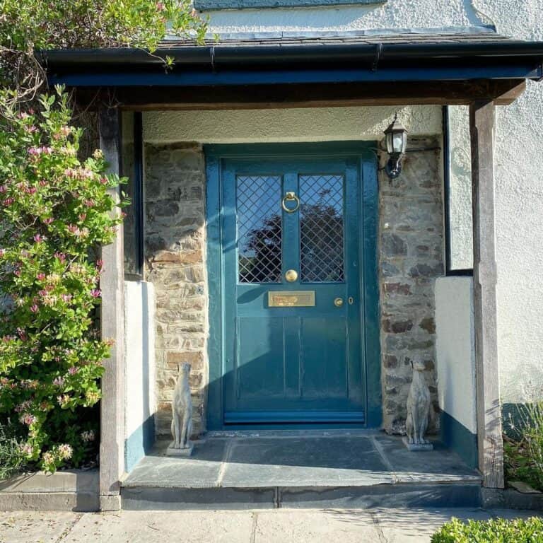 Glossy Inchyra Blue Front Door with Stone Wall Porch - Soul & Lane