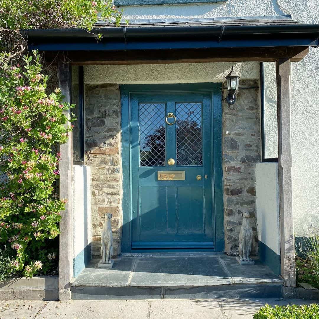 Glossy Inchyra Blue Front Door with Stone Wall Porch - Soul & Lane