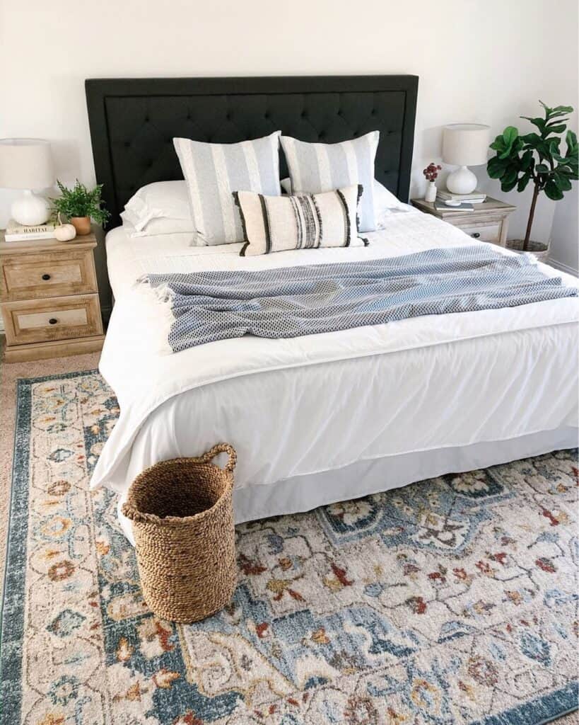 Wicker Basket on a Light Blue Rug Under a Bed - Soul & Lane