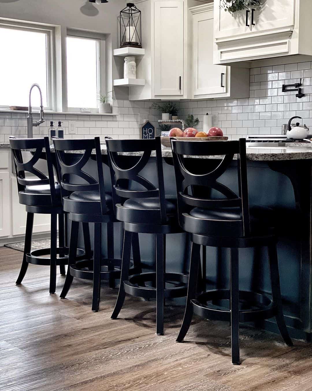 Black Bar Stools With a Back Under Mottled Grey Counter - Soul & Lane