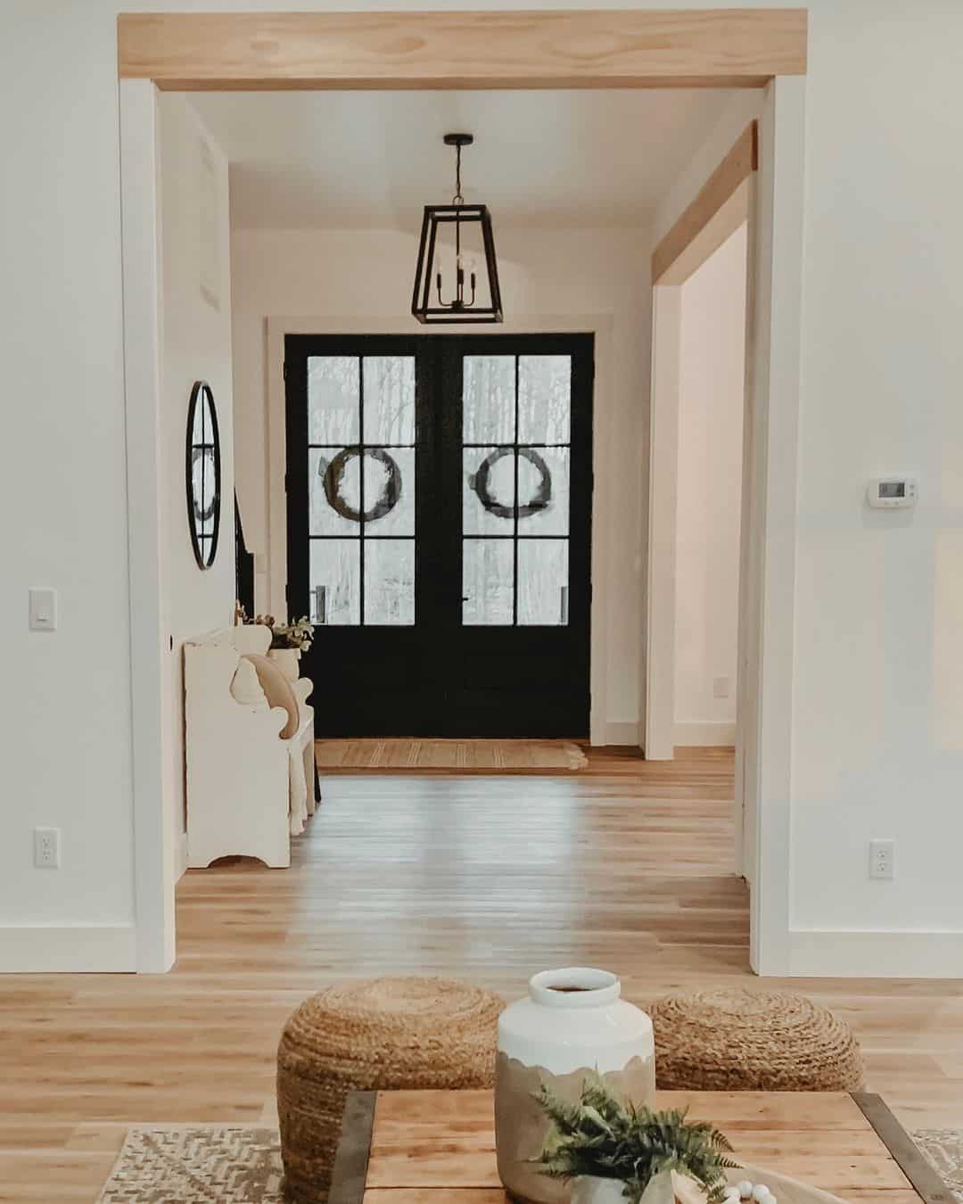 Black Front Doors Contrasting with Light Wood Entryway - Soul & Lane