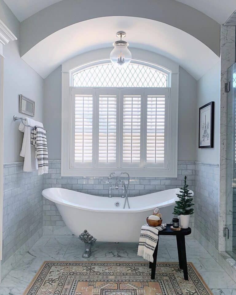 Arched Bathroom Window Behind Clawfoot Bathtub - Soul & Lane