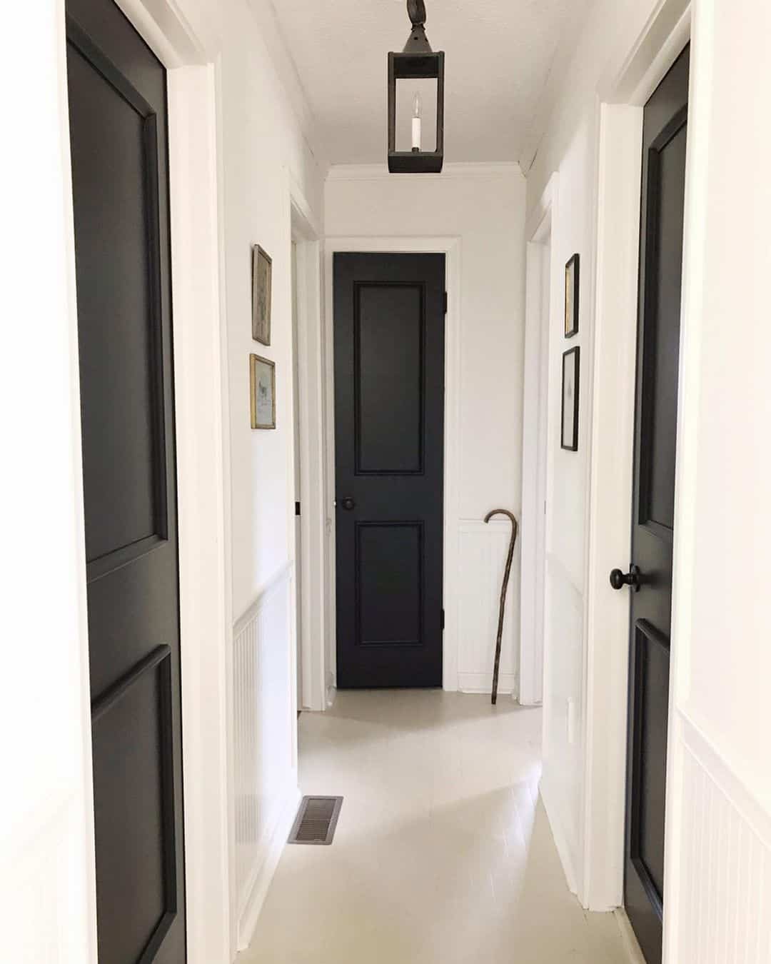 Black Hallway Doors Contrast With White Walls - Soul & Lane