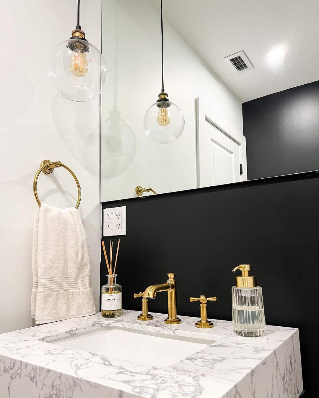 Modern and Luxurious Powder Room with Gold Accents - Soul & Lane