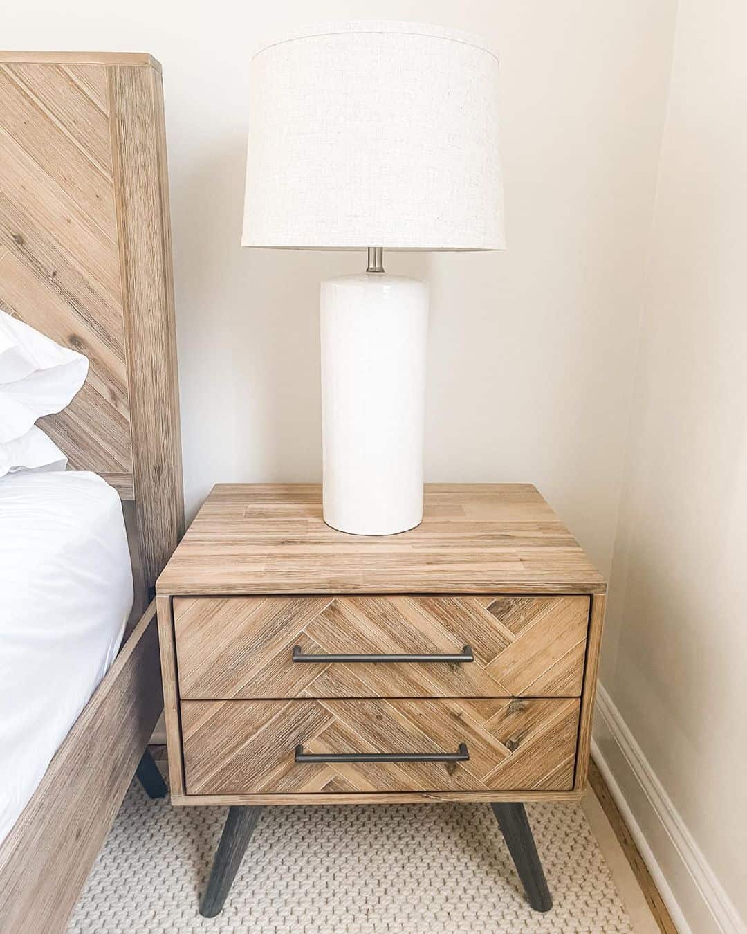 White Lamp on a Natural Wood Herringbone Nightstand - Soul & Lane