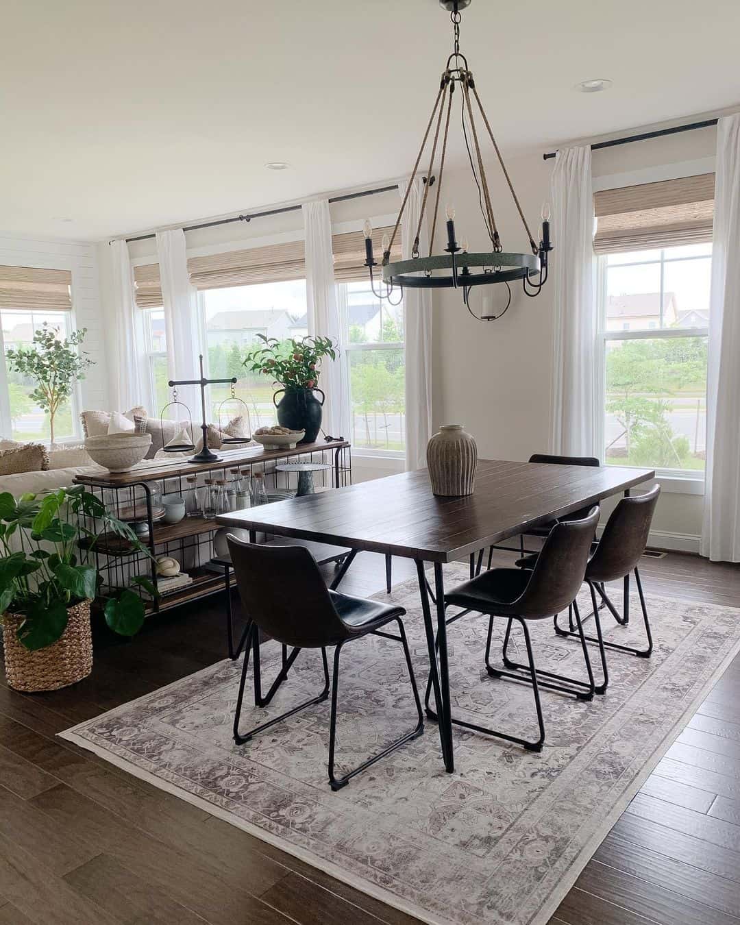 Black Chandelier, White Curtains, and a Large Green Plant - Soul & Lane Black Chandelier, White Curtains, and a Large Green Plant - Soul & Lane