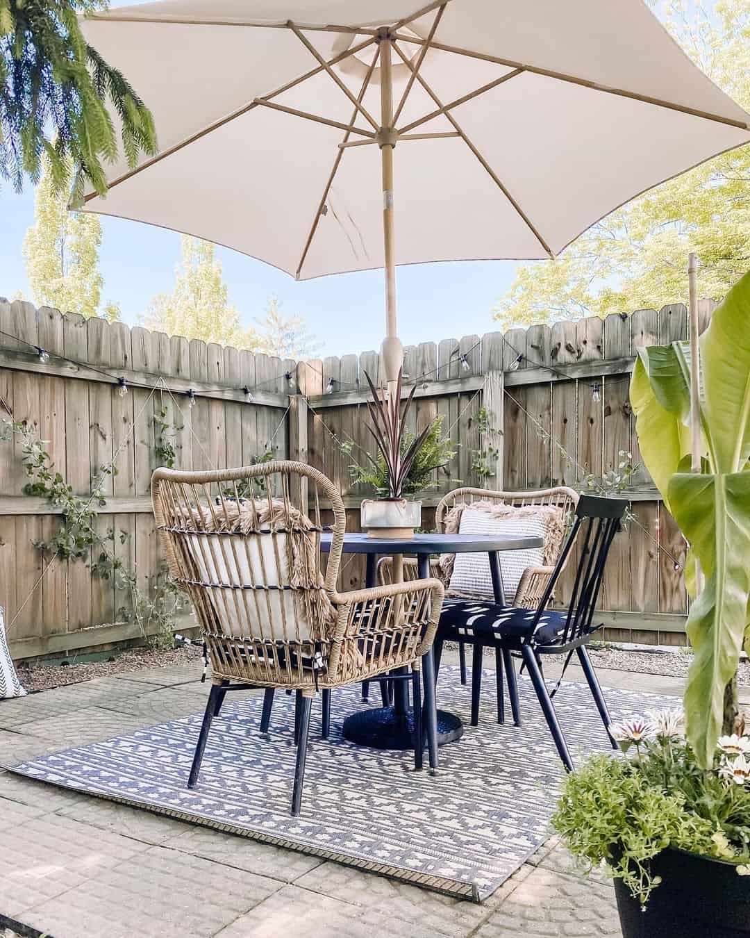 Small Outdoor Patio With Round Table and Large Umbrella - Soul & Lane