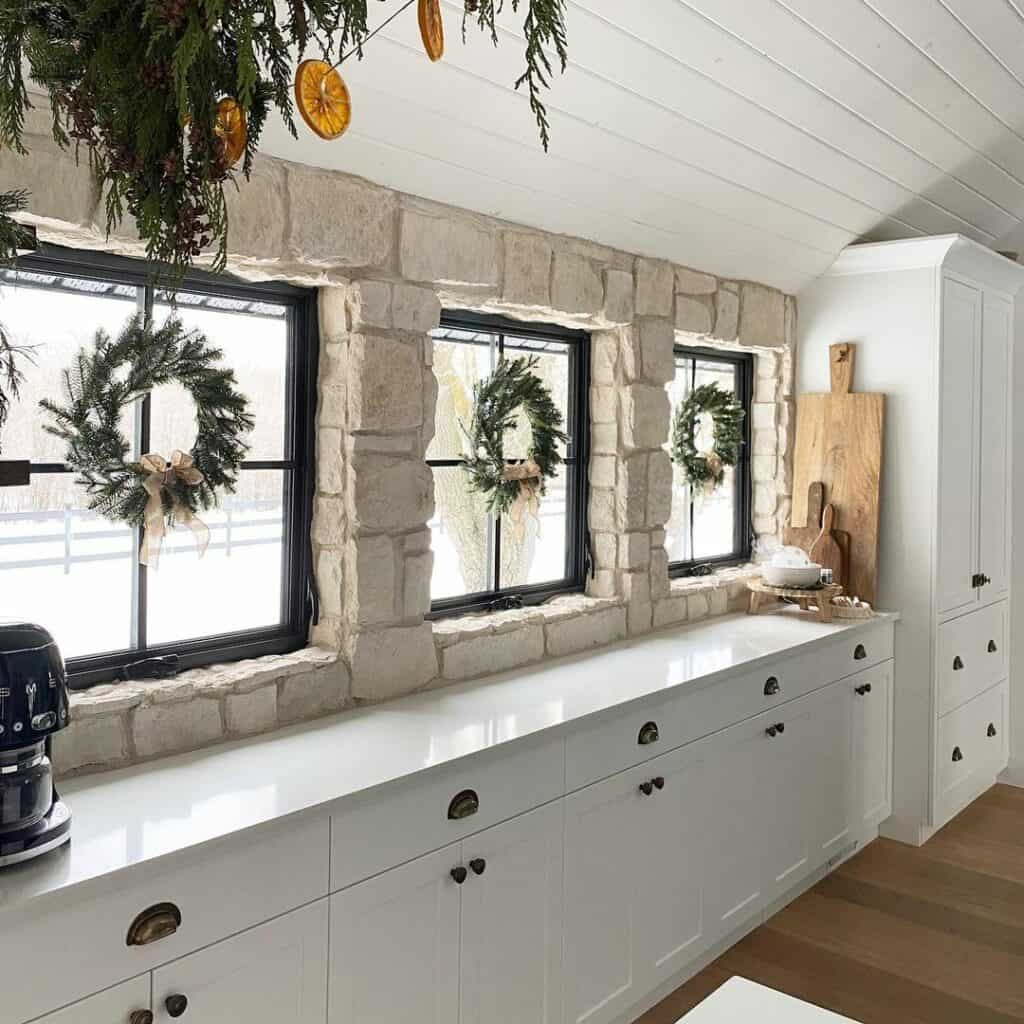 Wreaths on Windows in a Natural Stone Kitchen - Soul & Lane