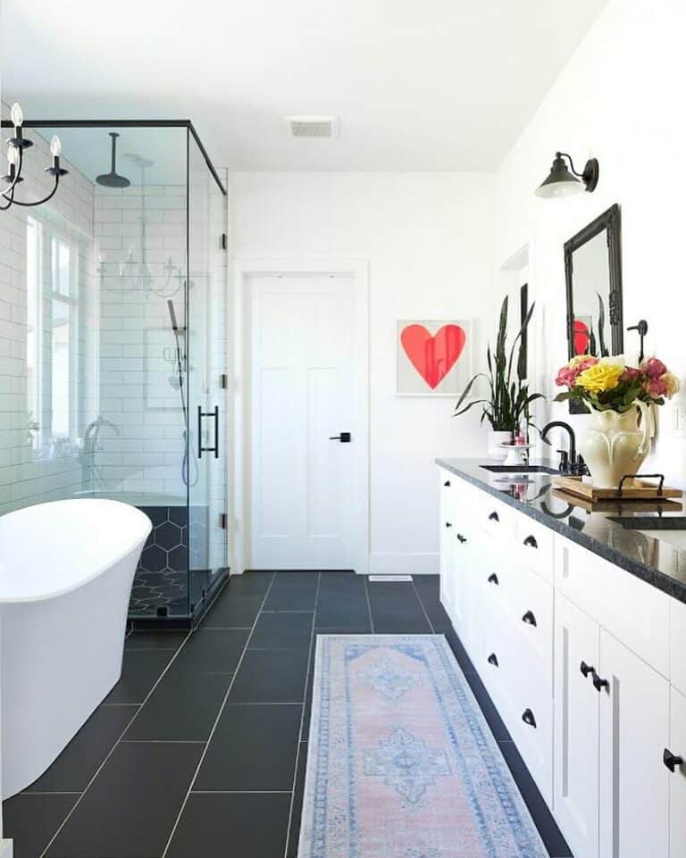 Black and White Farmhouse Bathroom With Black Tile Flooring - Soul & Lane