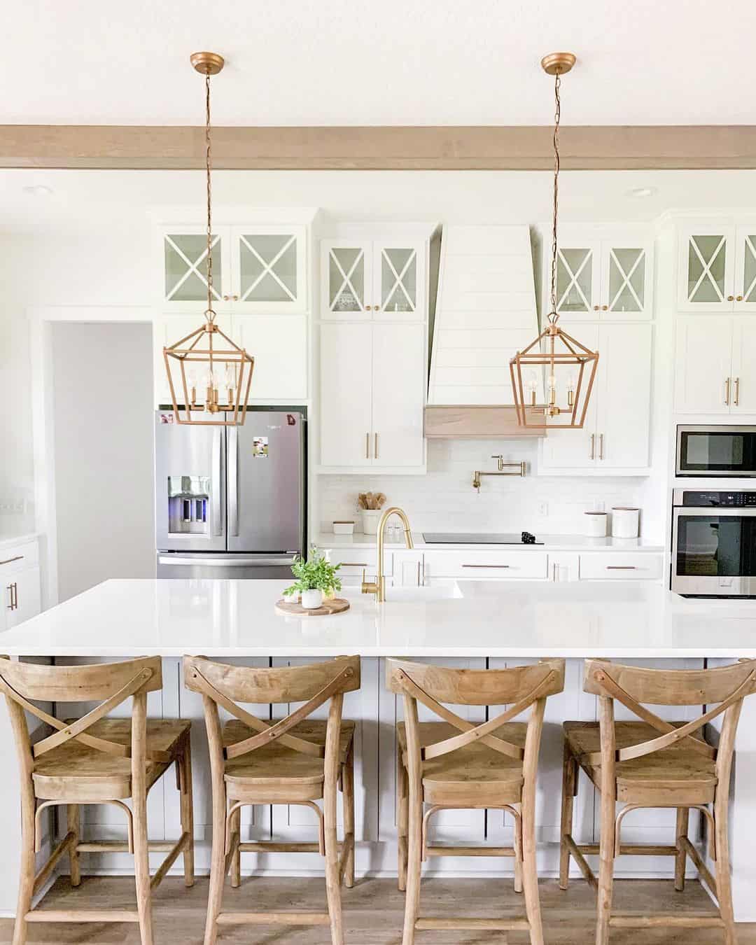 Elegant White Kitchen With Brass Light Fixtures and Marble Countertop ...