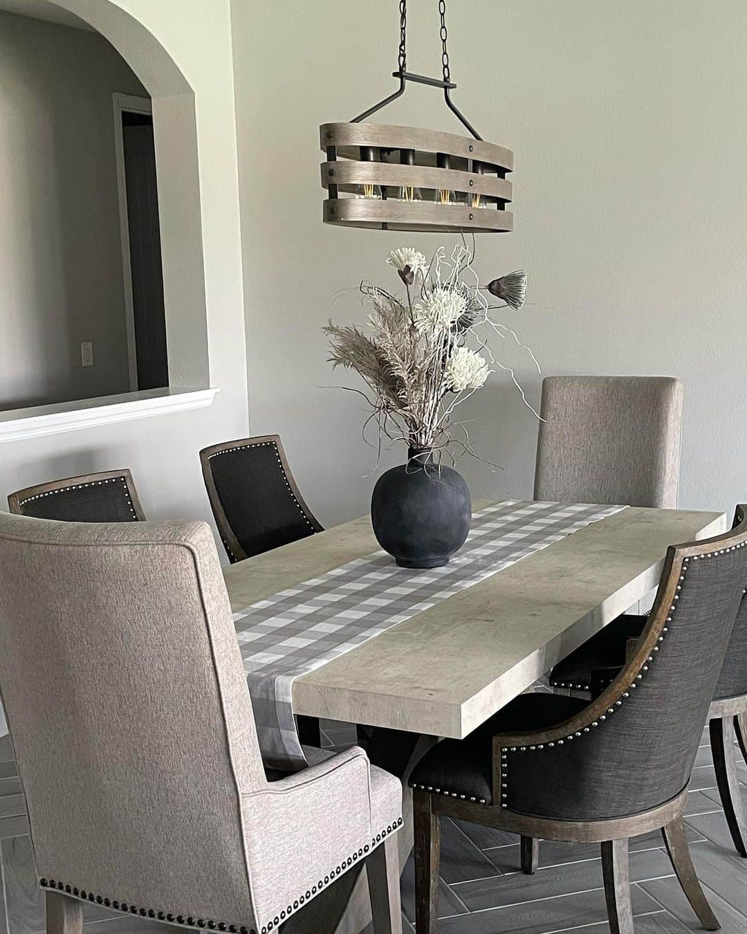 Quiet Dining Space With a Gray Herringbone Tile Floor - Soul & Lane