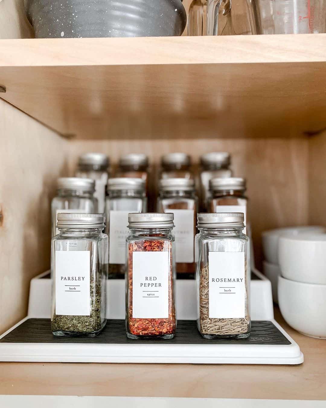 Spice Bottles Displayed on a Tiered Platform - Soul & Lane