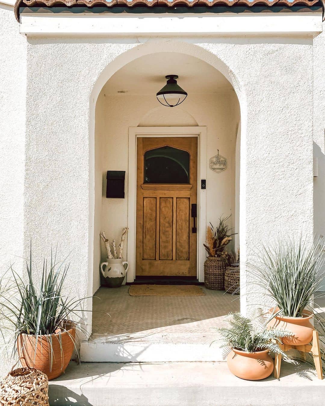 Bohemian Entryway With Wooden Front Door - Soul & Lane