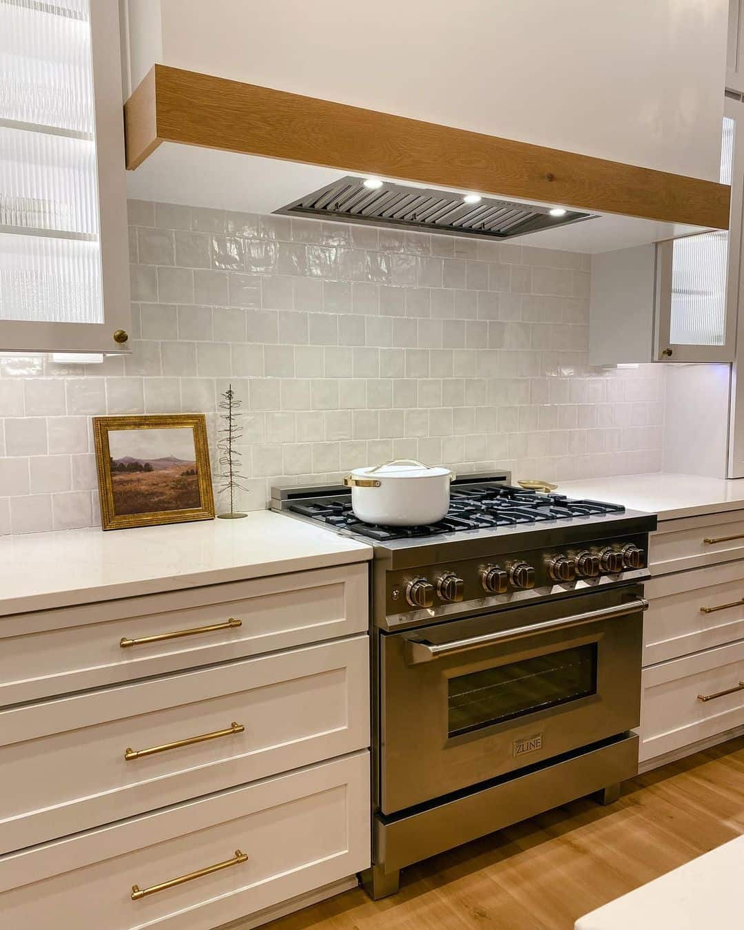 Range Hood Between Waterfall Glass Cabinets - Soul & Lane